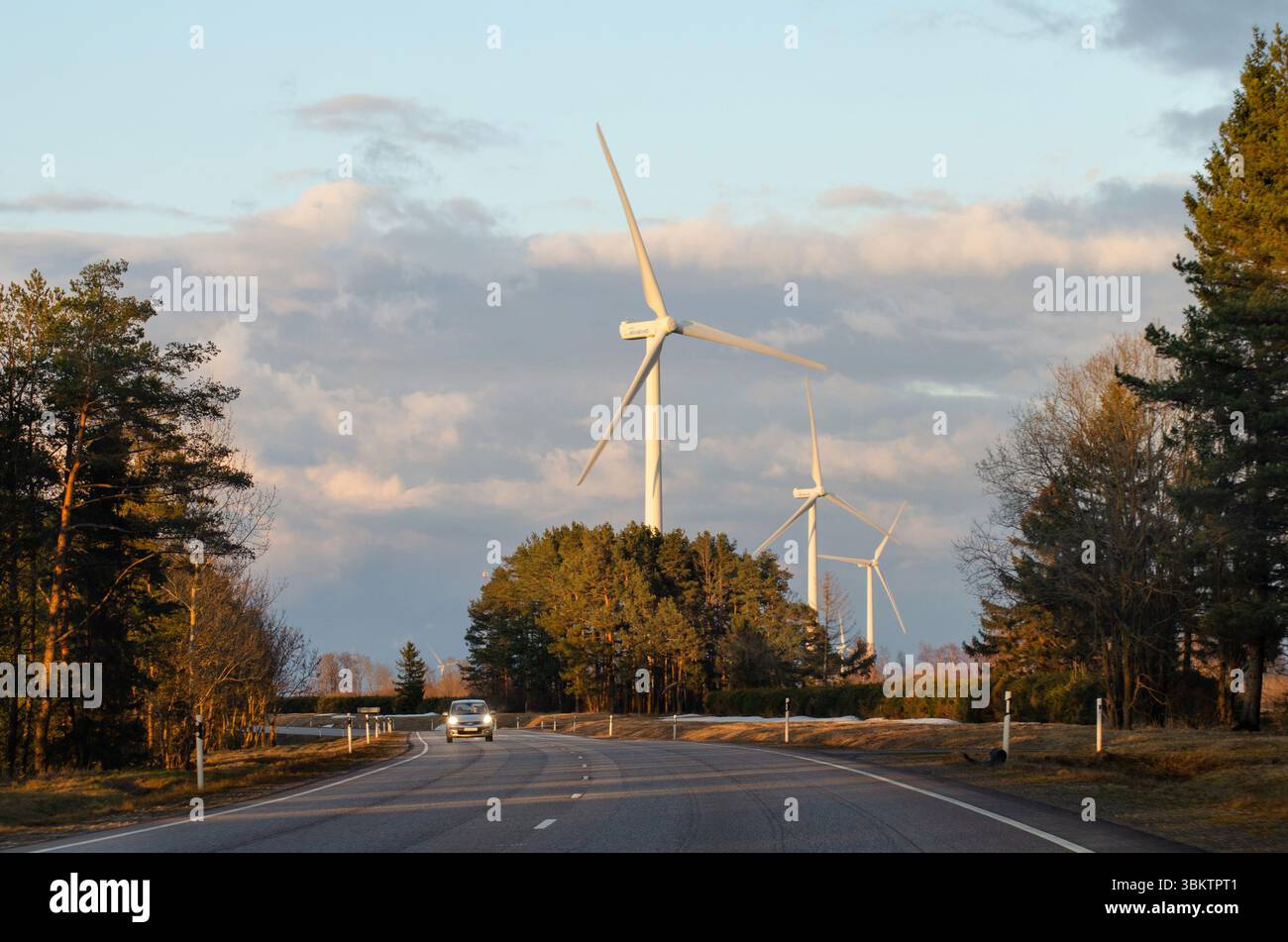 Wind turbines along a forest road Stock Photo - Alamy