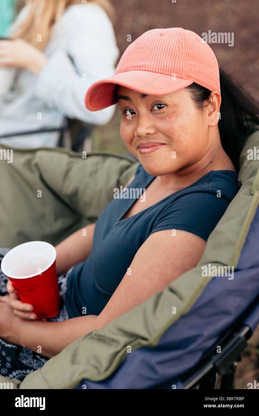 Woman relaxing in camping chair hi-res stock photography and images - Alamy