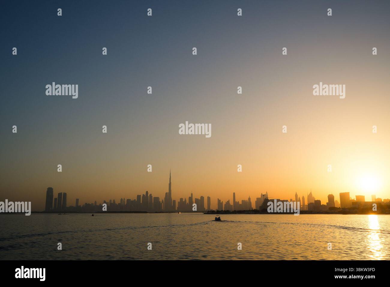 Breathtaking sunset view in Dubai with calm ocean waves and the iconic ...