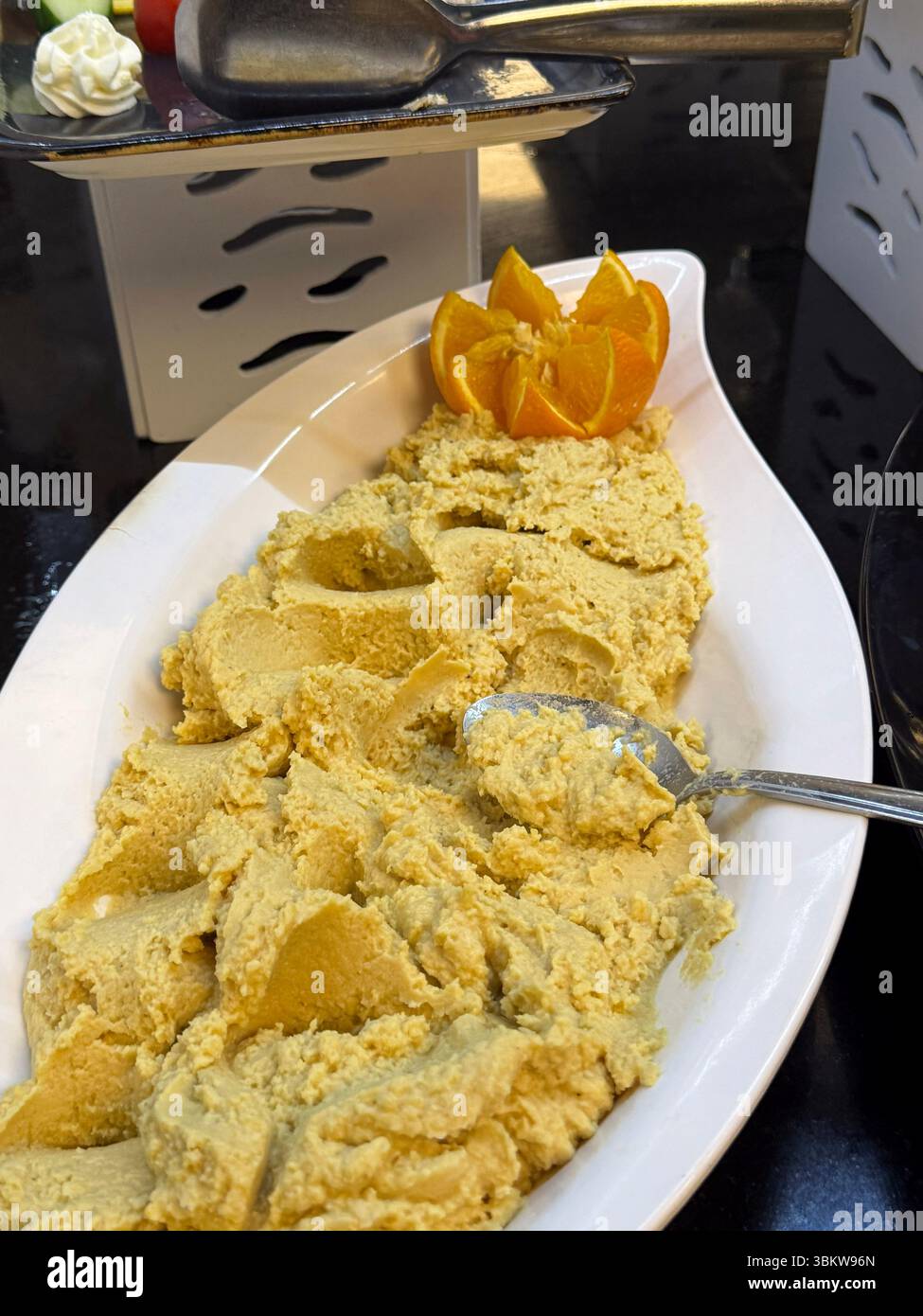 Hummus Served at Hotel Buffet Table. Fresh hummus in a large serving ...