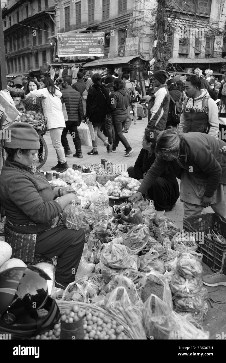 Vendors sell produce to shoppers in a bustling street market Stock ...