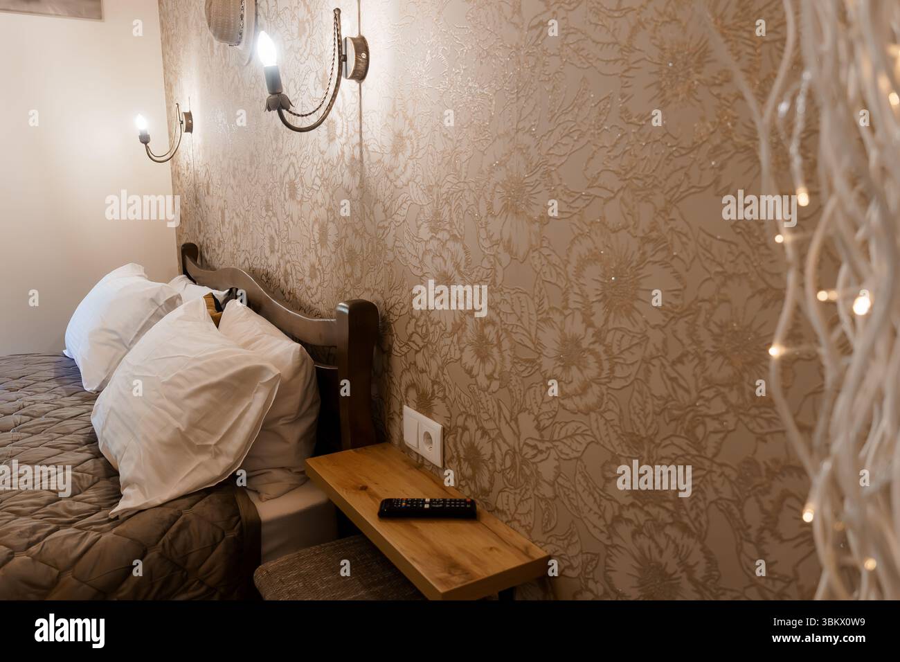 Intimate bedroom setting with a comfortable bed, patterned wallpaper ...