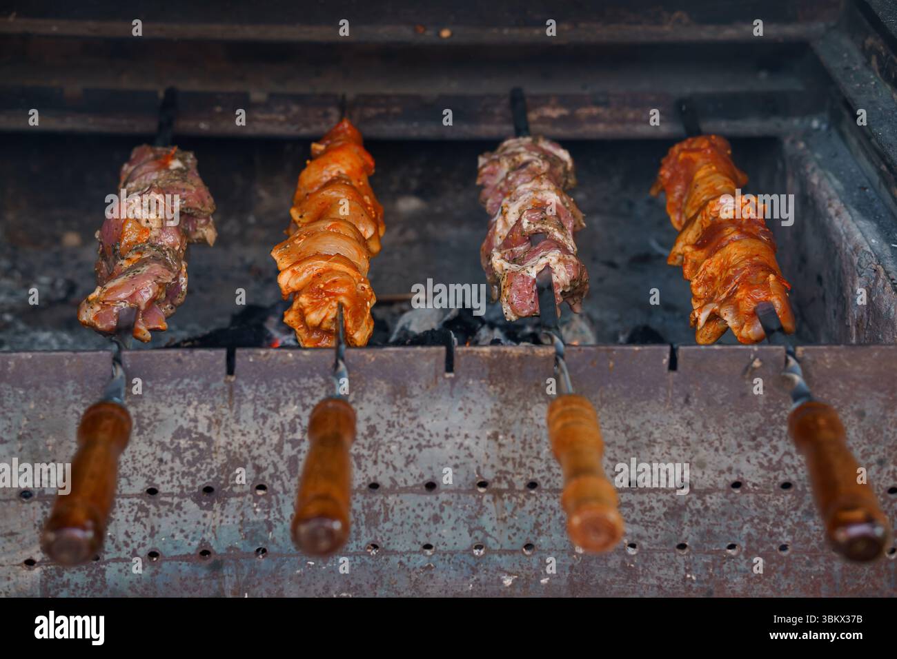Authentic Brazilian churrasco scene featuring skewers of seasoned meats ...