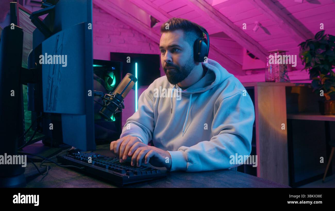 Concentrated guy male gamer streamer man wearing headphones gaming at ...