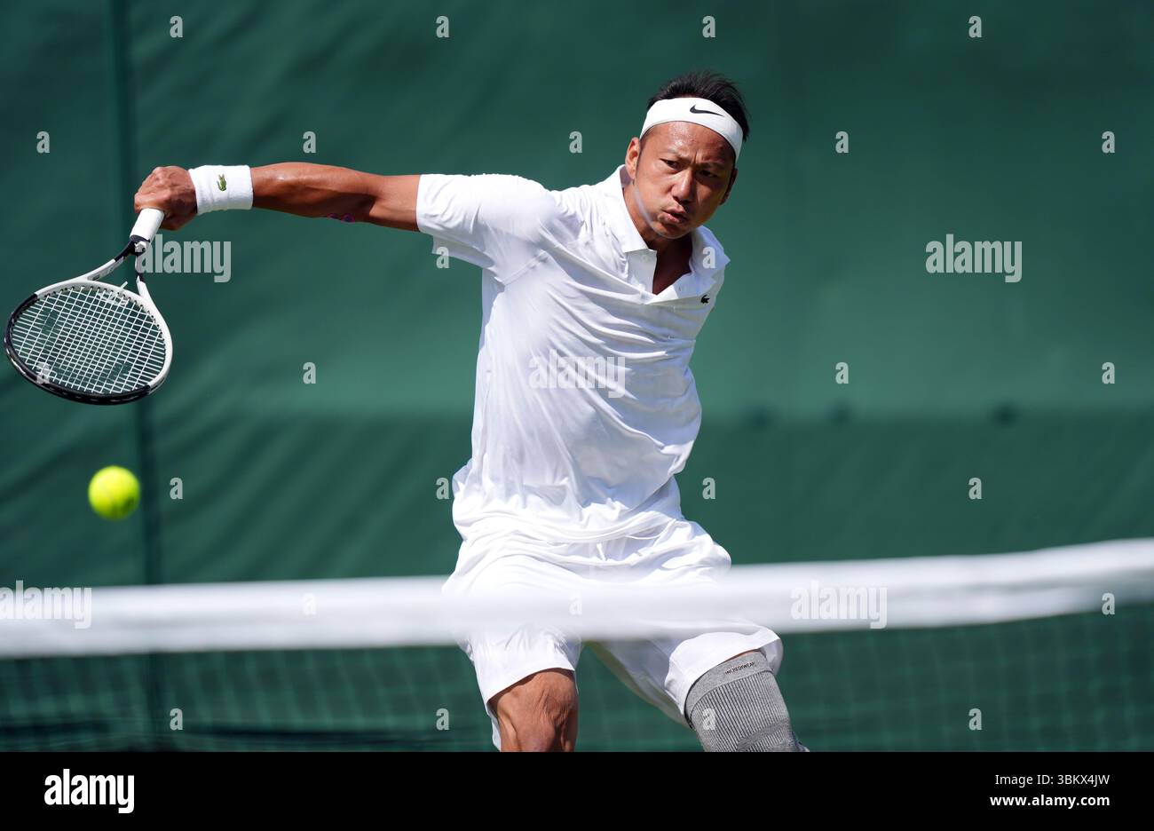 Yan Bai in action against Nicolai Budkov Kjaer, during Wimbledon ...