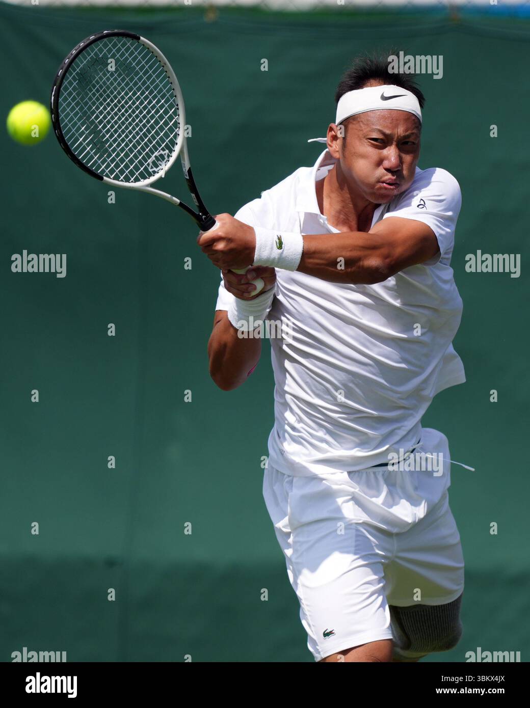 Yan Bai in action against Nicolai Budkov Kjaer, during Wimbledon ...