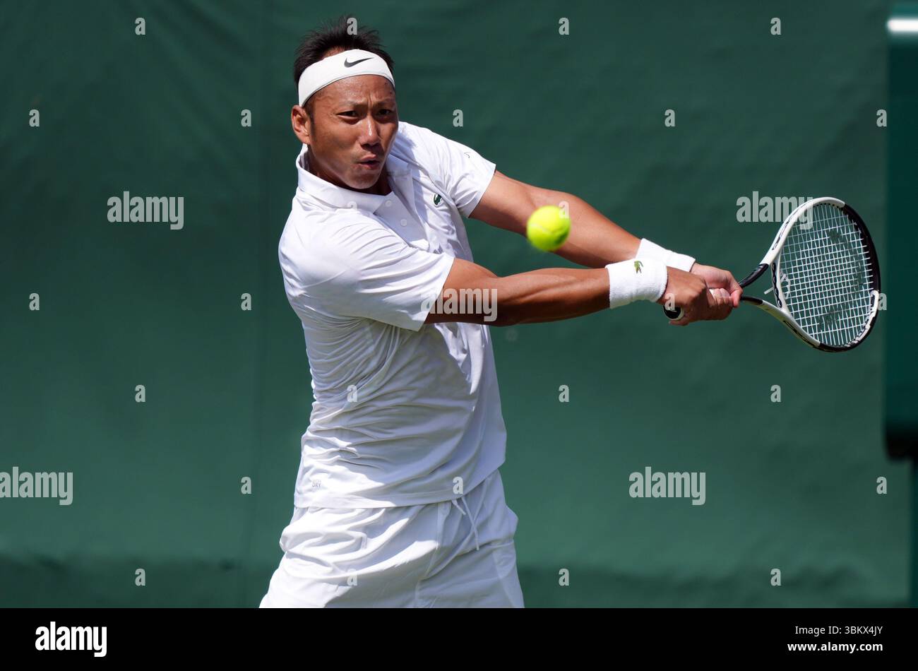 Yan Bai in action against Nicolai Budkov Kjaer, during Wimbledon ...