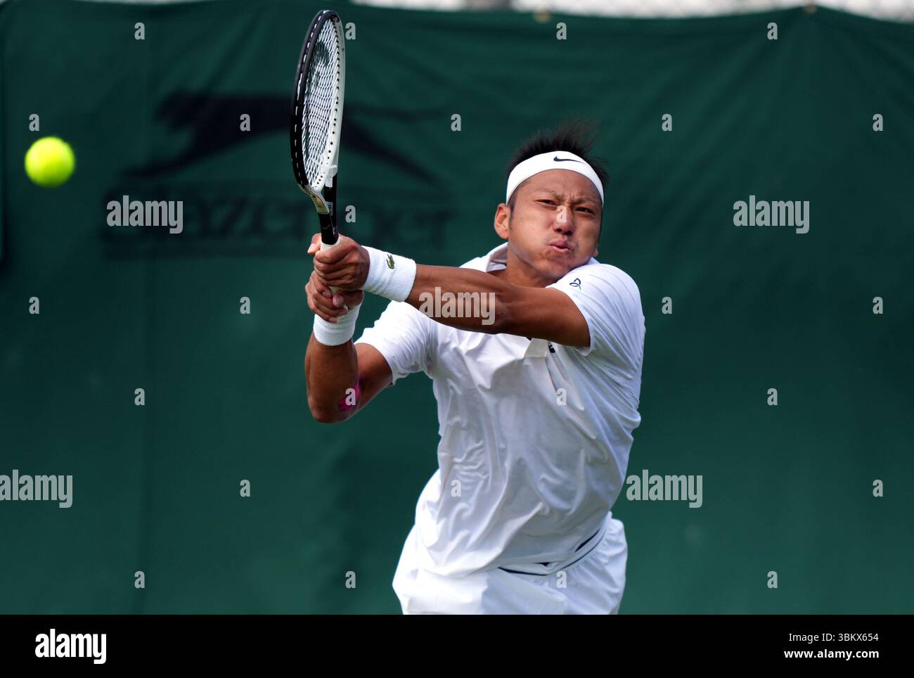 Yan Bai in action against Nicolai Budkov Kjaer, during Wimbledon ...