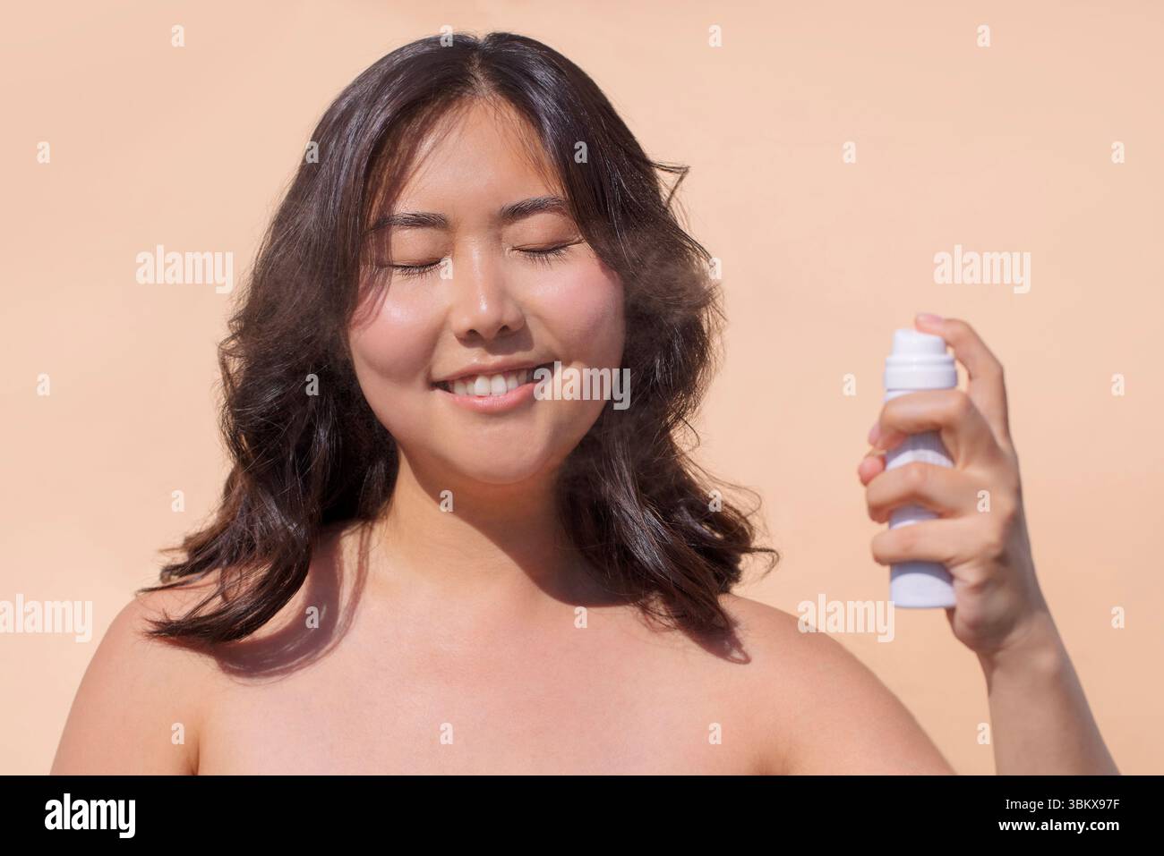 Female applying facial mist hi-res stock photography and images - Alamy
