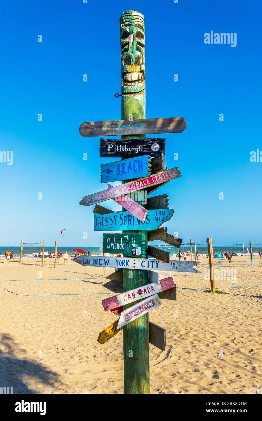 Colorful travel direction signs on a totem pole at Cocoa Beach, Florida ...