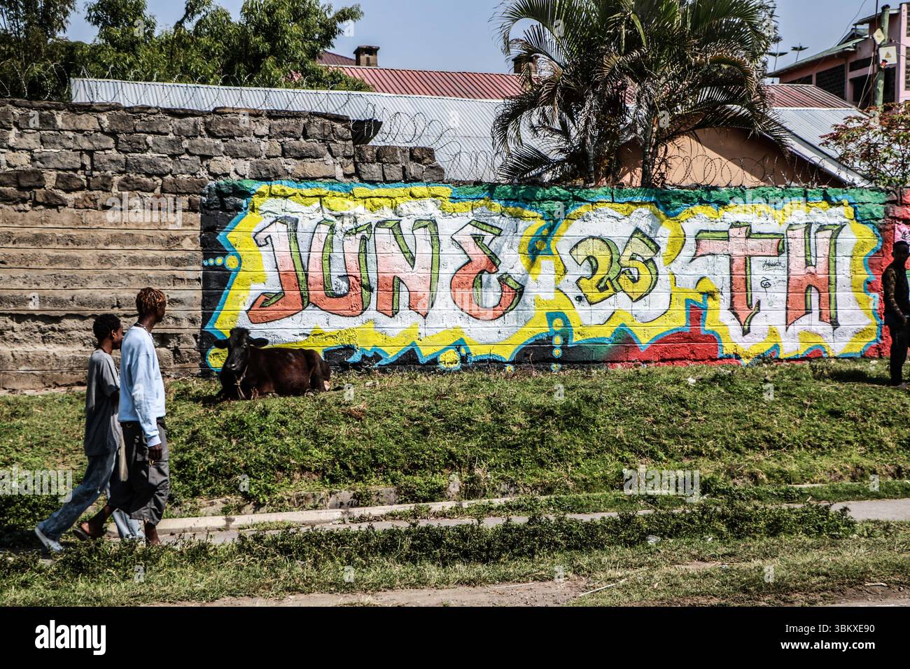 People walk past a graffiti mural marking the first anniversary of anti ...