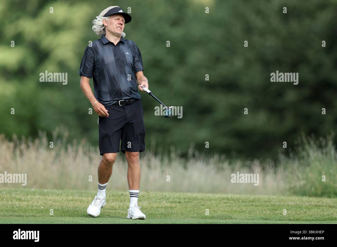 Former Premier League footballer Jimmy Bullard reacts after a putt on ...