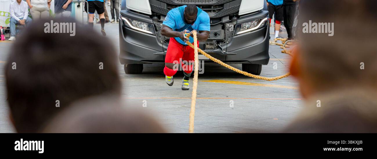 Strong athlete, muscular bodybuilder, competing in strongman event ...