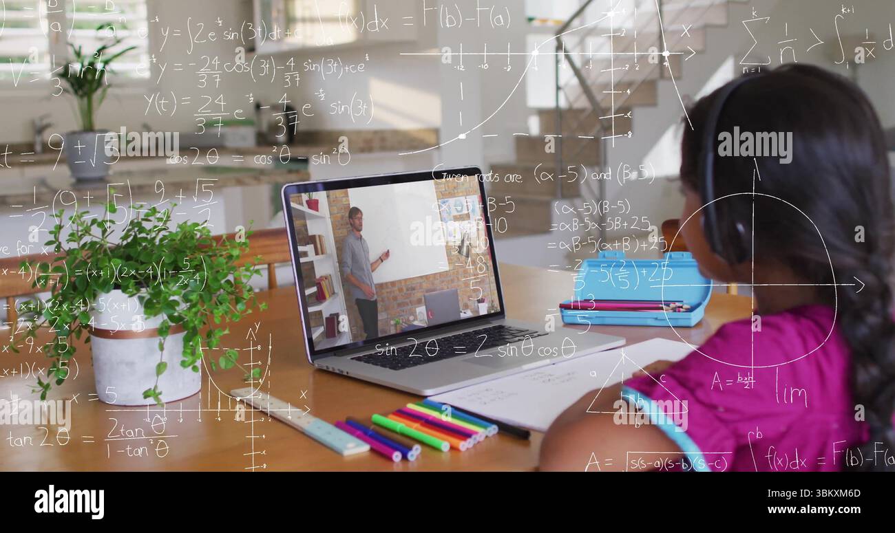 School-age girl studying in home study area, following teacher on ...
