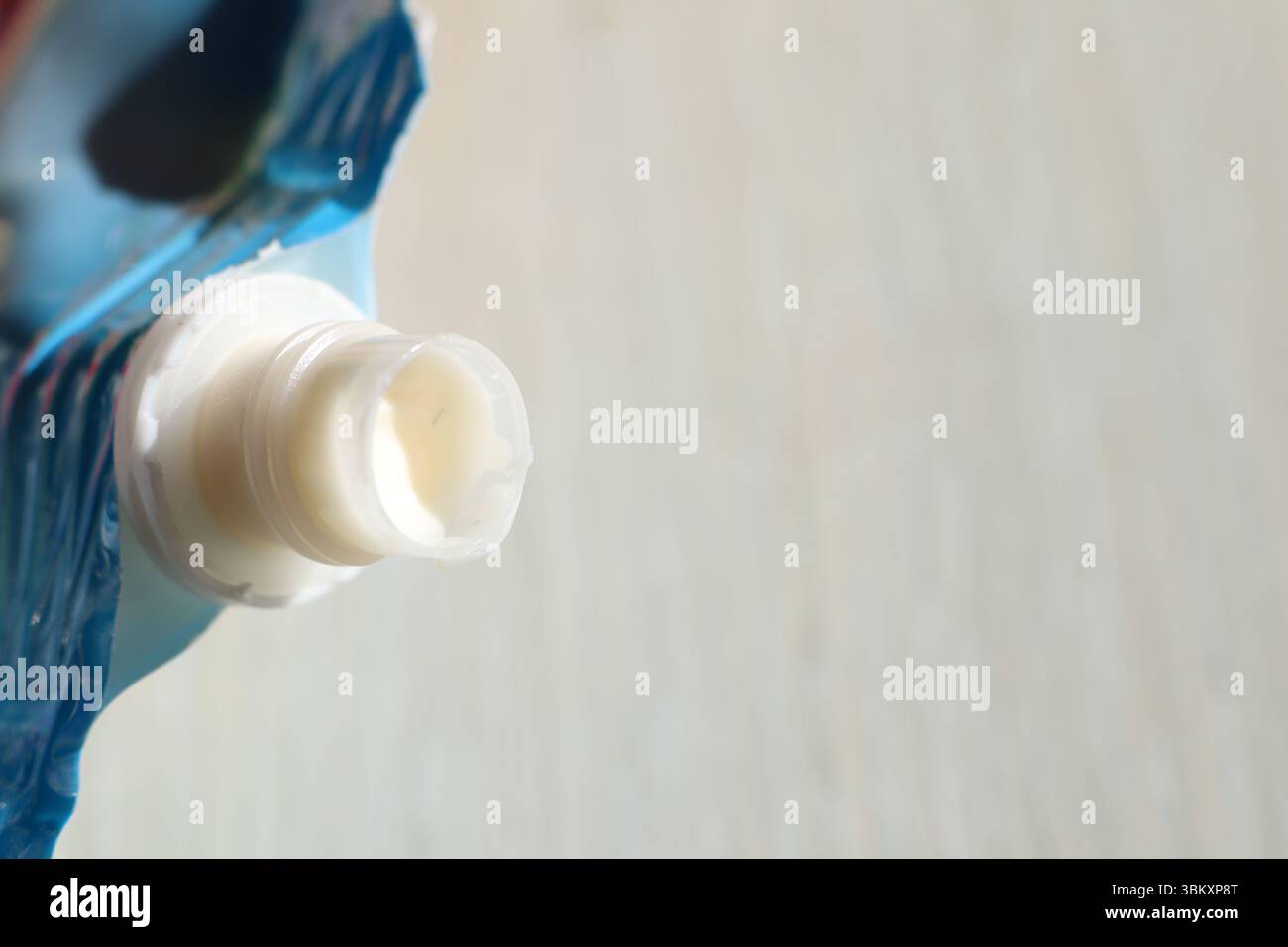 Here is a detailed view of a squeeze tube, showcasing its creamy ...