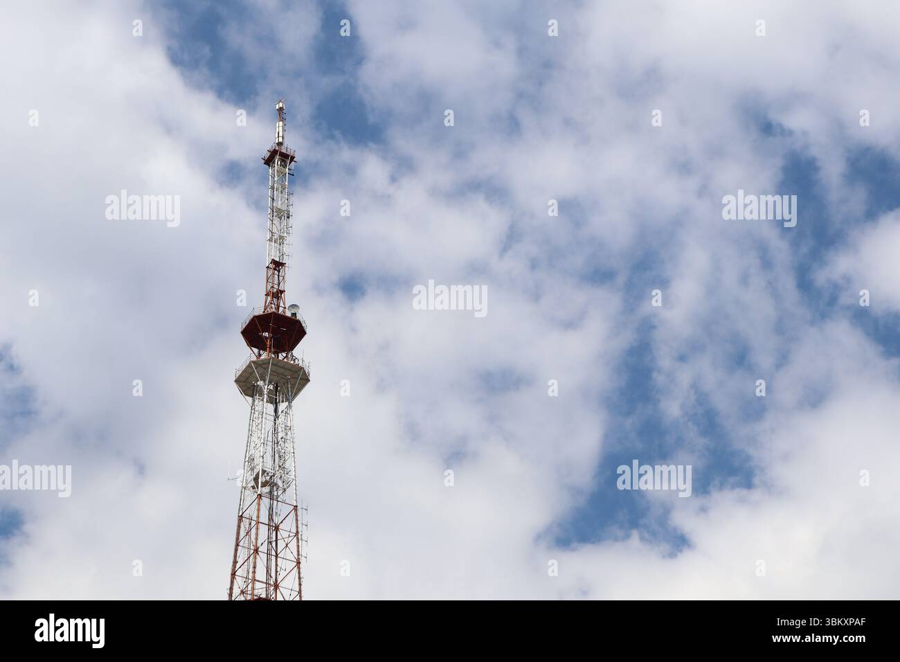 A tall telecommunications tower is rising majestically into a bright ...