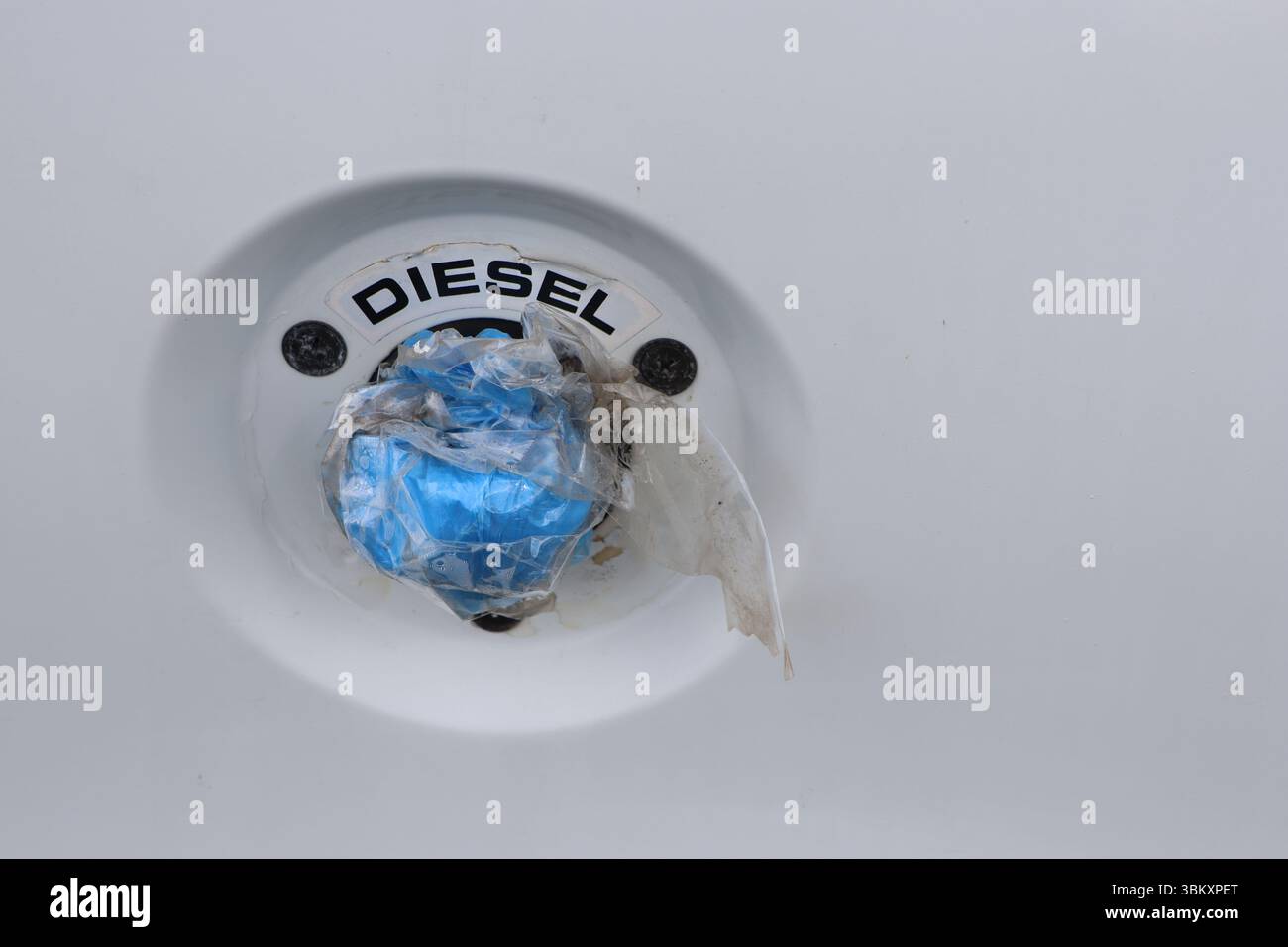 This image shows a diesel fuel cap covered in plastic, highlighting the ...