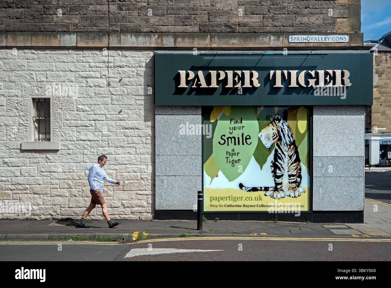 Man walking towards branch of the Paper Tiger, a stationery shop in ...