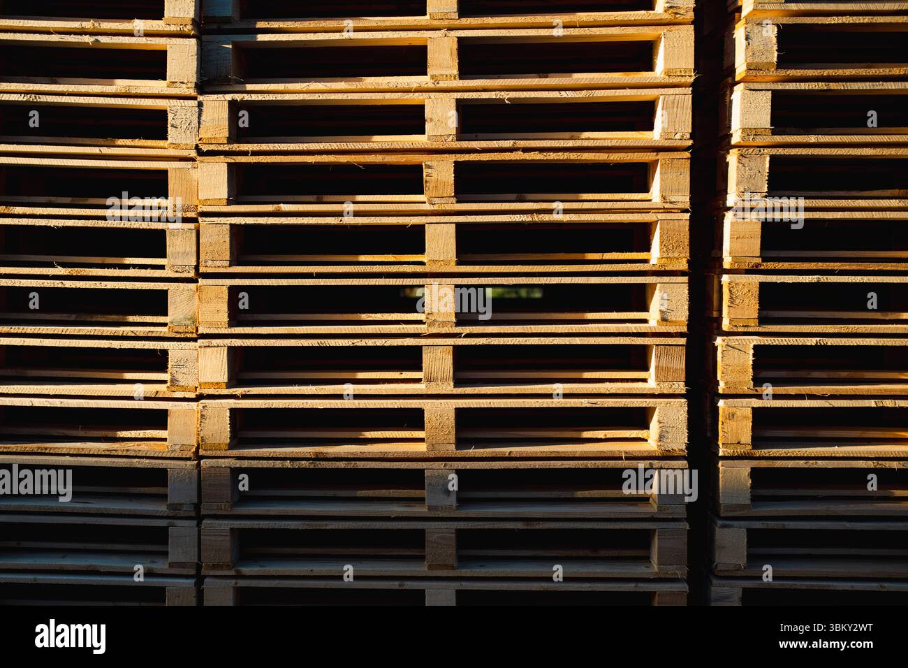 Neatly organized stack of wooden pallets, creating a rhythmic pattern ...