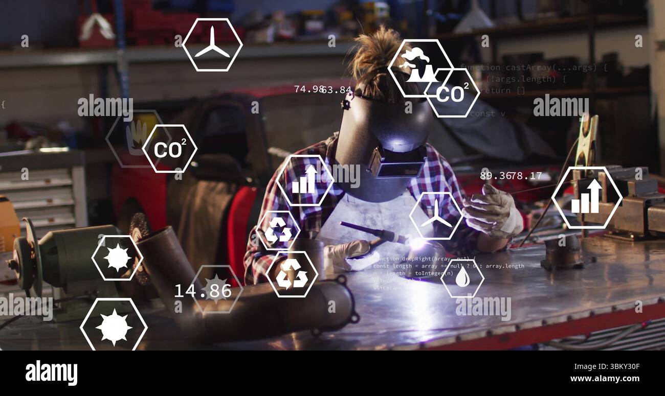 Welding woman wearing helmet holding torch generating sparks at ...