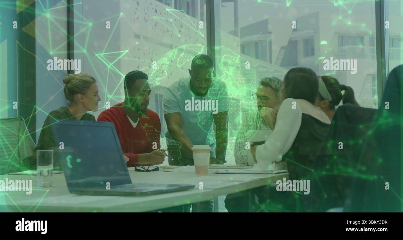 Colleagues leaning over documents discussing hi-res stock photography ...