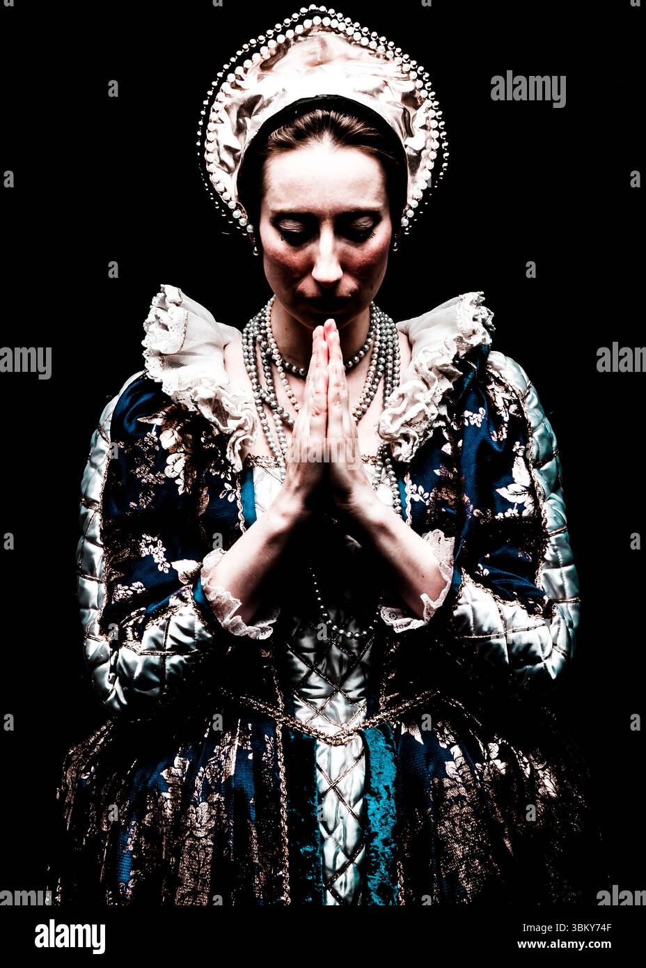A woman dressed in historical attire, possibly from the Renaissance ...