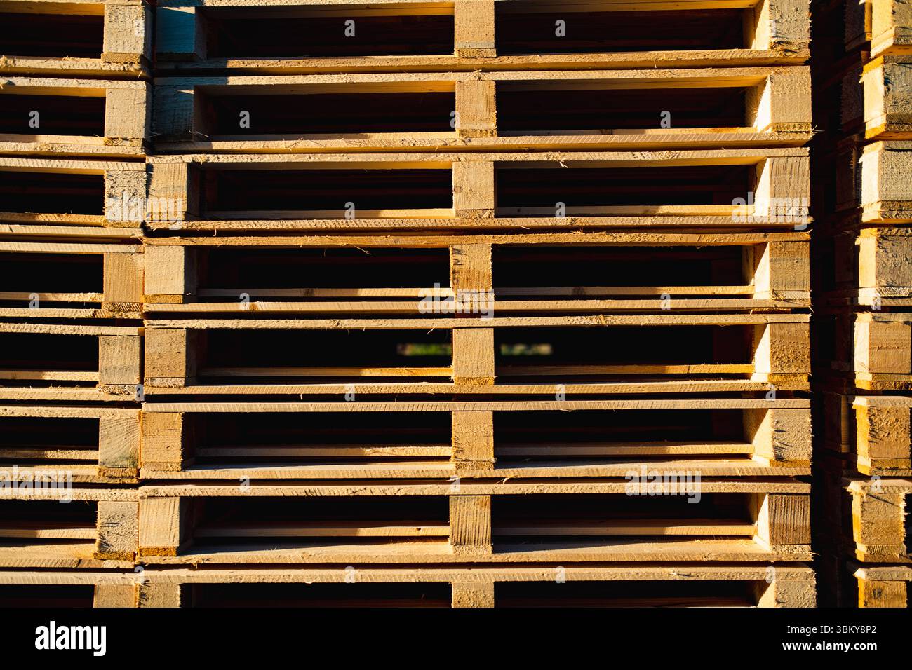 Neatly organized stack of wooden pallets, creating a rhythmic pattern ...