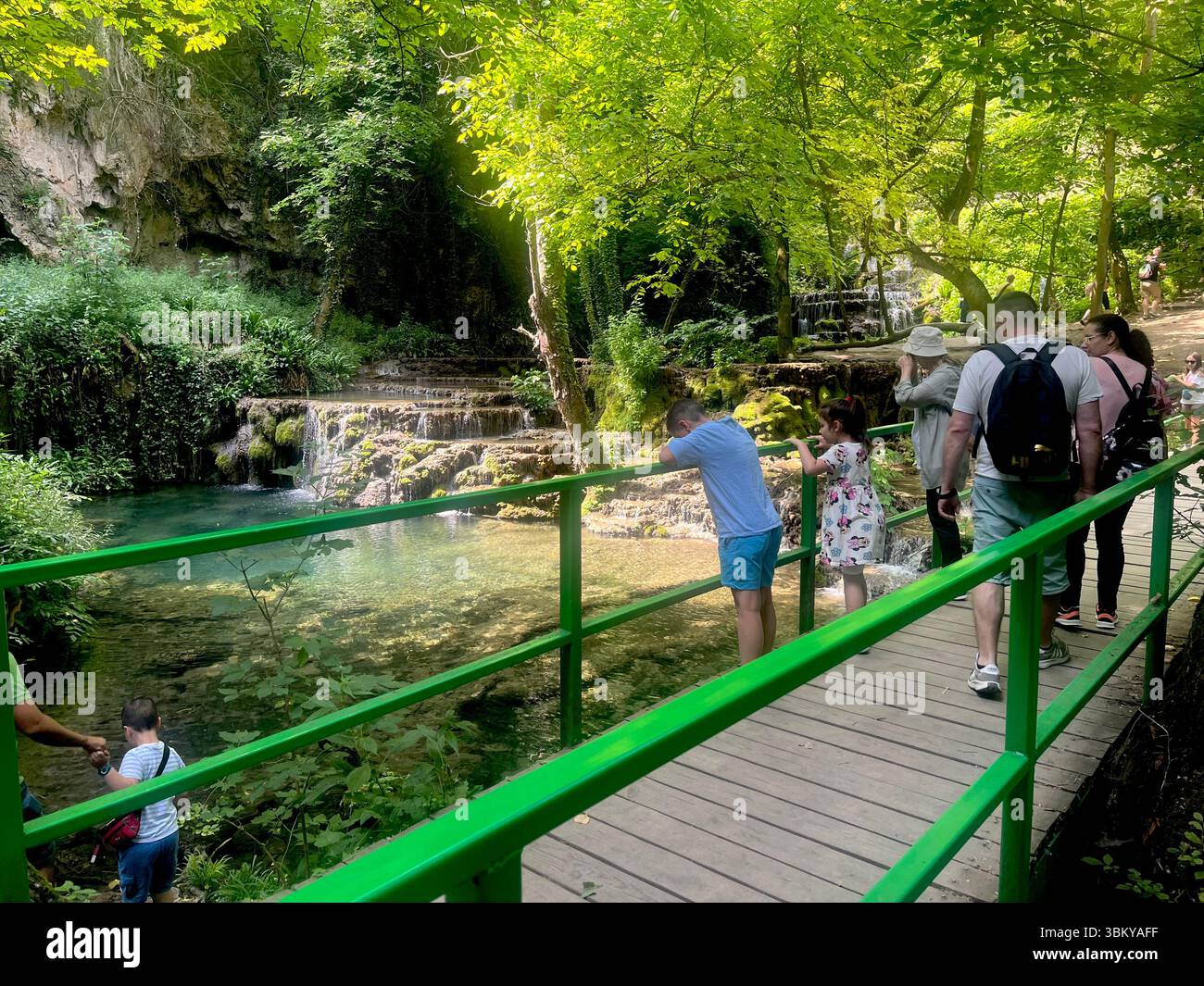 Tourists enjoy hiking the scenic trails of Krushuna Waterfalls in ...
