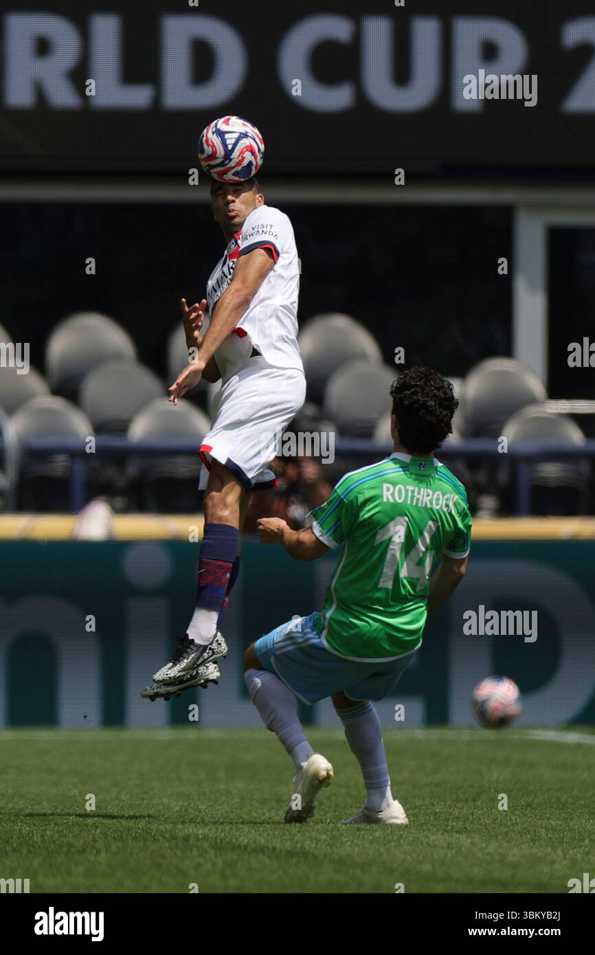 Paris Saint-Germain's Achraf Hakimi, left, heads the ball as Seattle ...