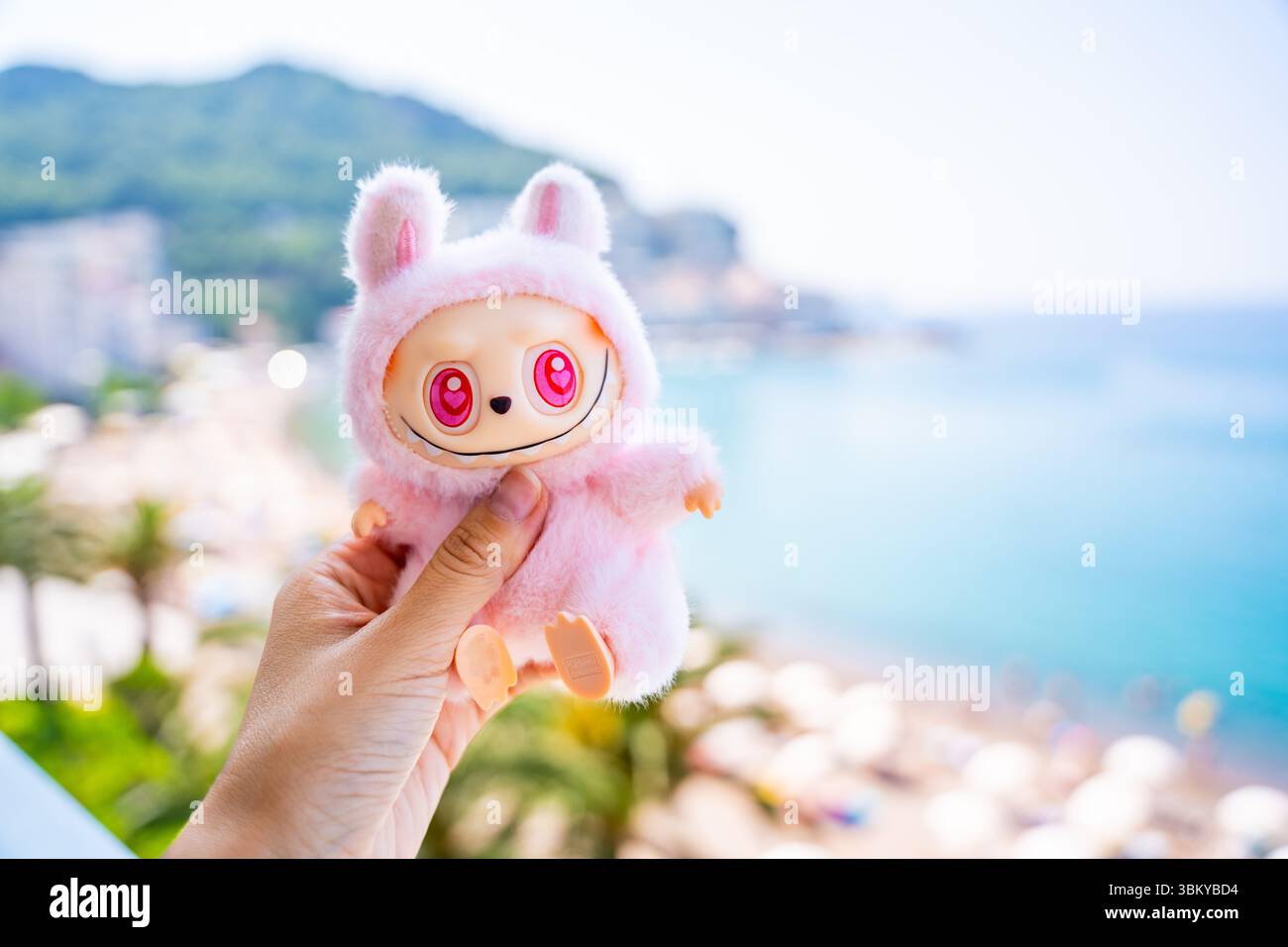 Budva, Montenegro - June 12, 2025: LaBubu toy from Pop Mart held in hand against blurred outdoor ...