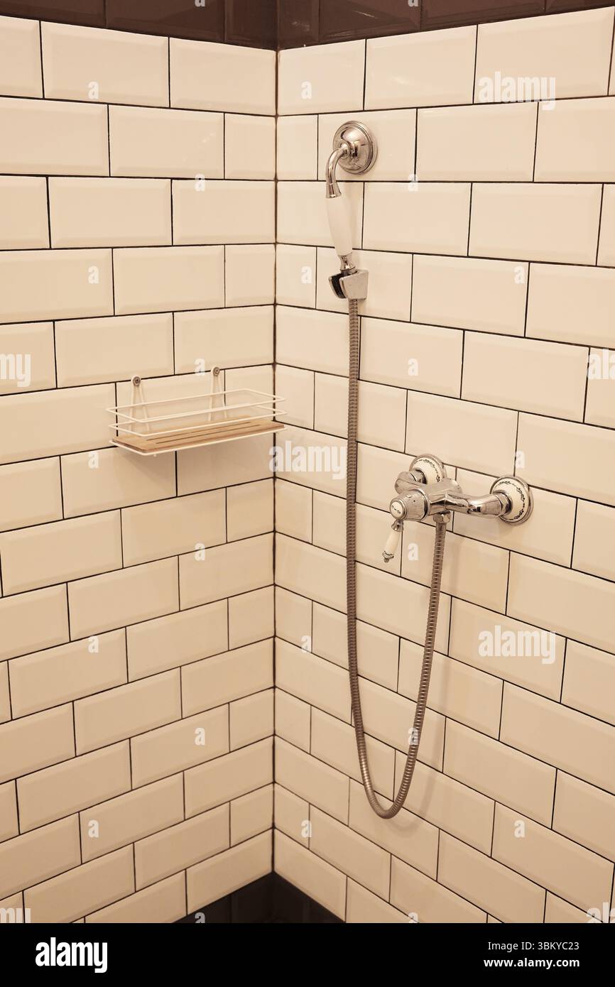Close-up of clean modern shower corner with classic white subway tiles ...