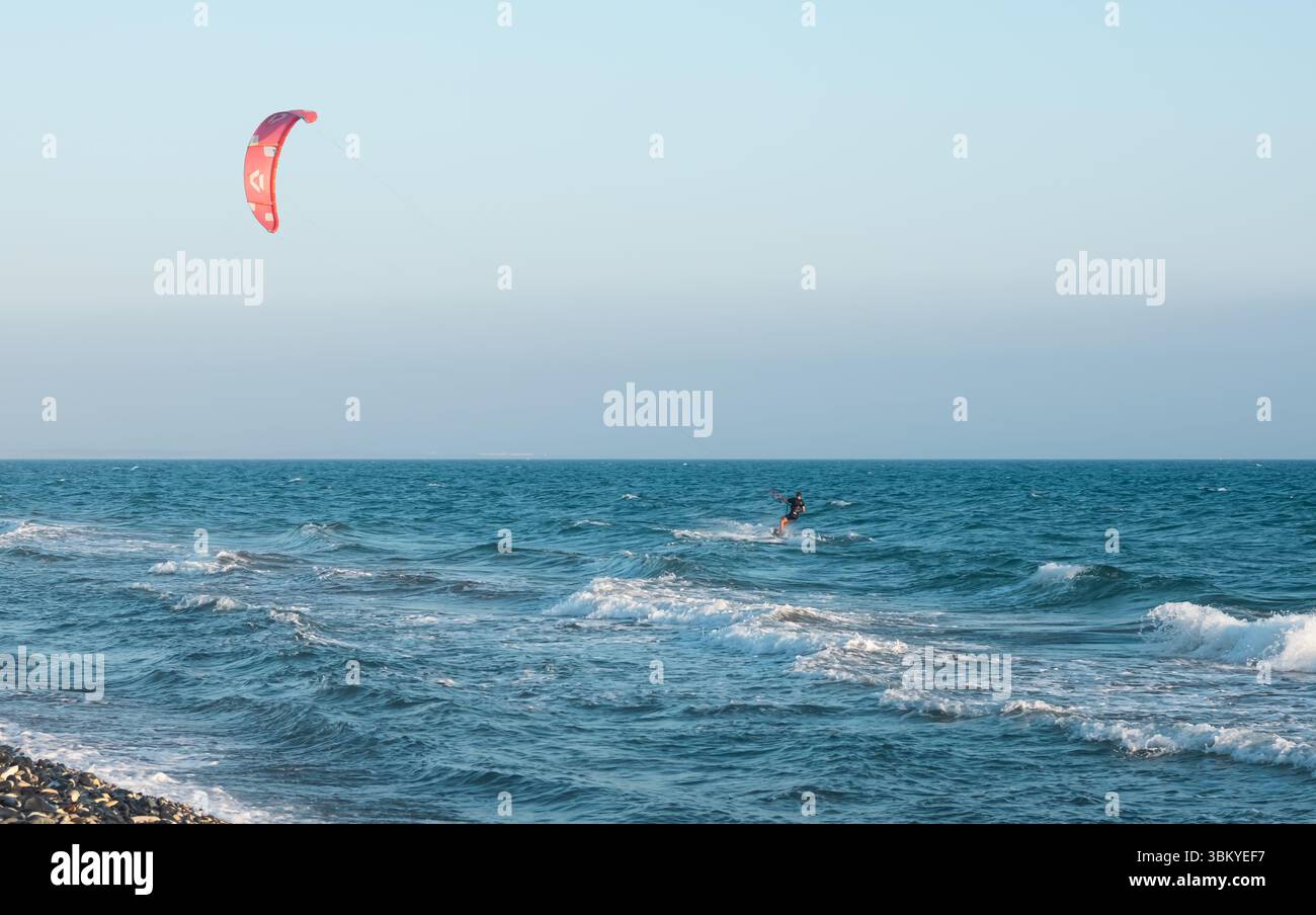Limassol, Cyprus, 06-20-2025. A young man doing kite surfing on the ...
