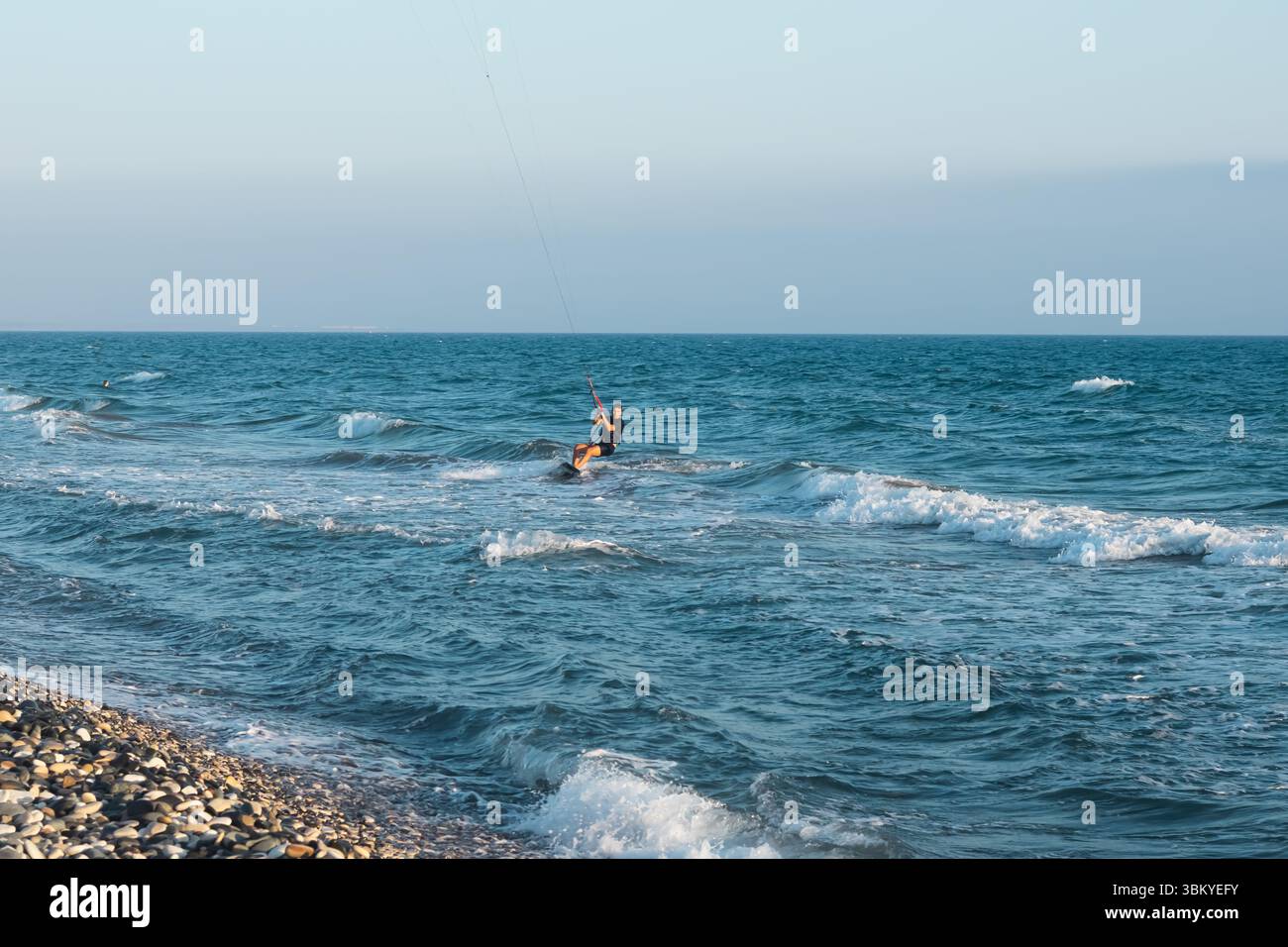 Limassol, Cyprus, 06-20-2025. A young man doing kite surfing on the ...