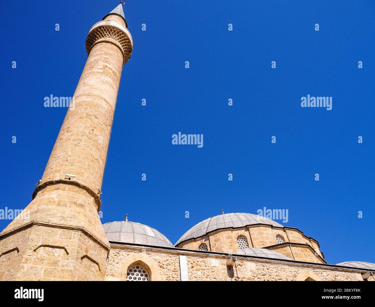 A low-angle shot showcases the architectural details of a mosque ...