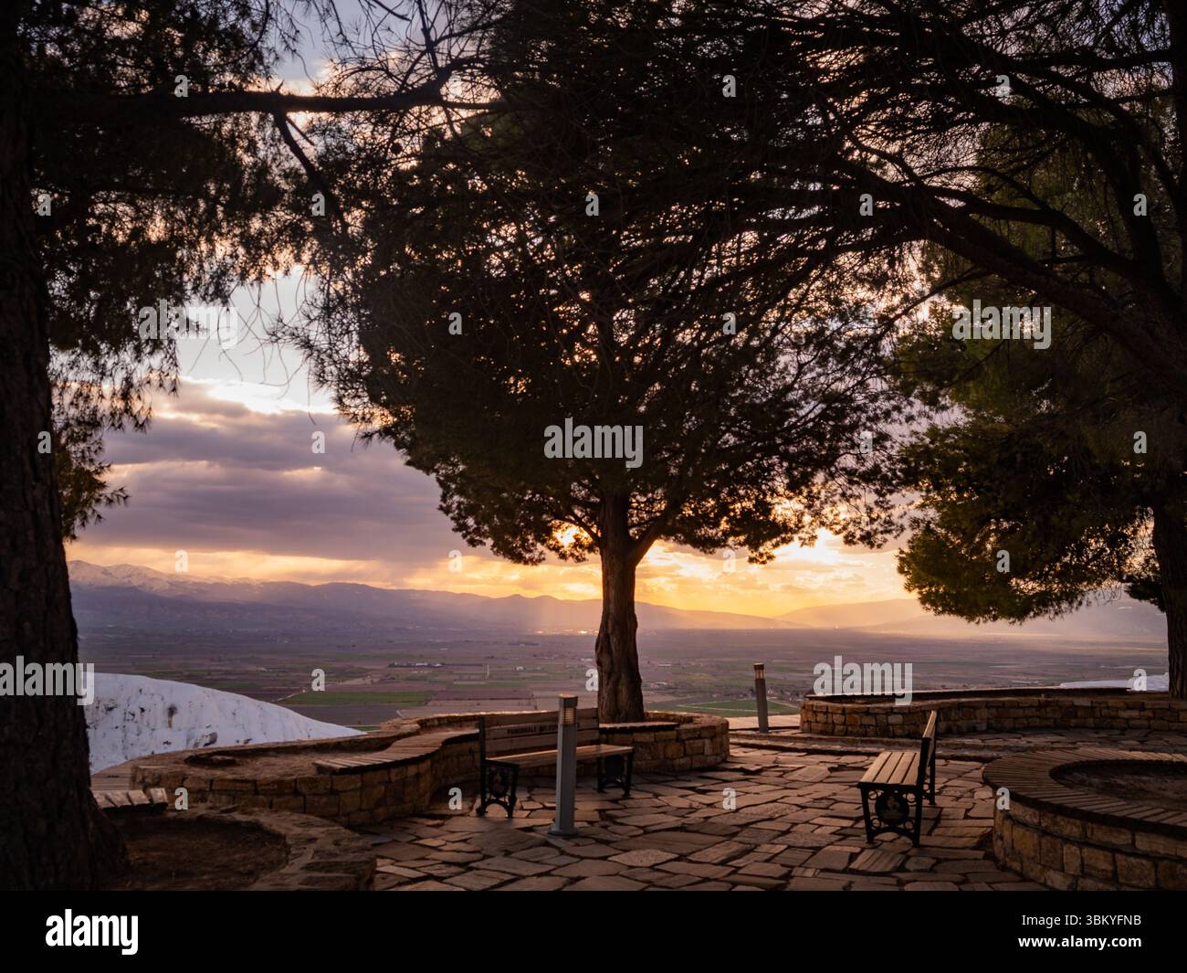 A scenic overlook with stone benches and a paved area provides a ...