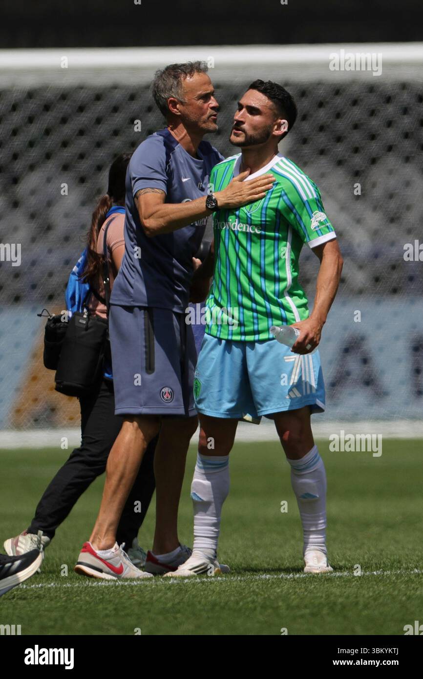 Paris Saint-Germain manager Luis Enrique, left, hugs Seattle Sounders ...