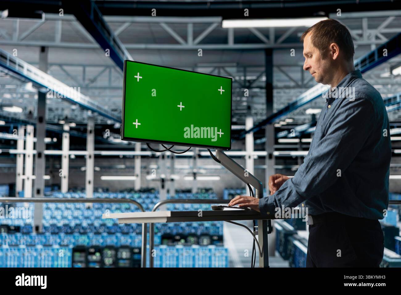 Data center admin using green screen PC to do programming, optimizing resource allocation. Man ...
