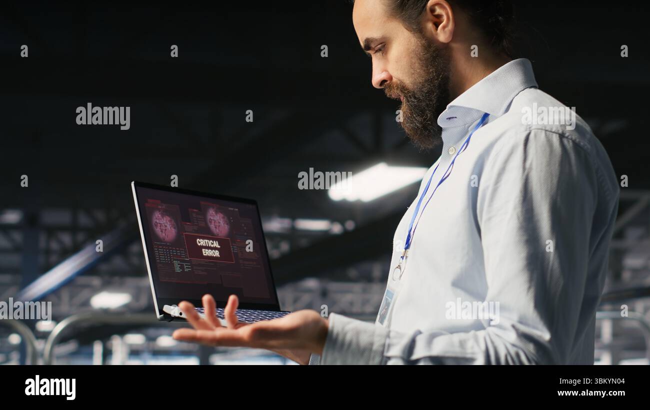 Annoyed engineer in data center reacting to critical error message on ...
