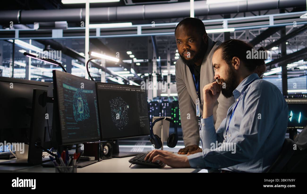 Supervisor in server room monitoring worker managing AI training datasets. African american team ...
