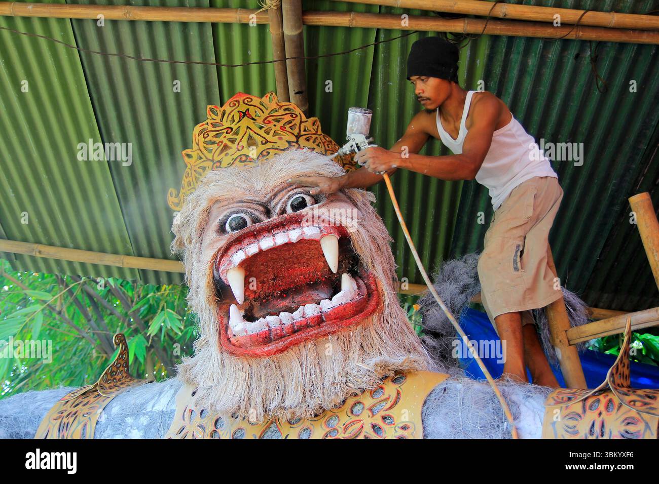 Man work on process of paint spraying the giant Hanuman Obong statue ...