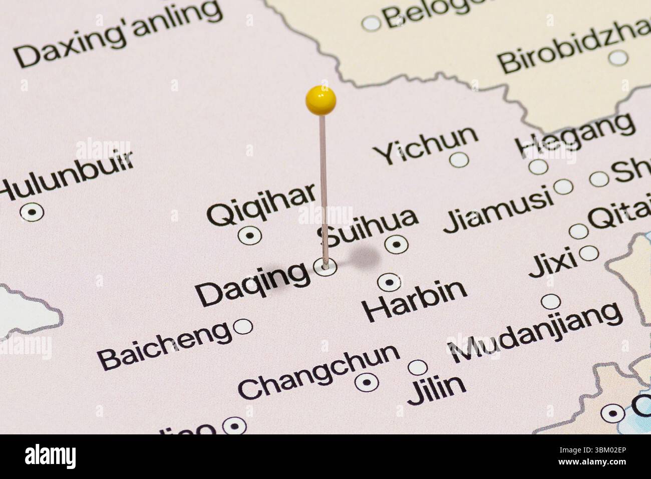 macro photo of a yellow pin needle into Daqing city of China political ...