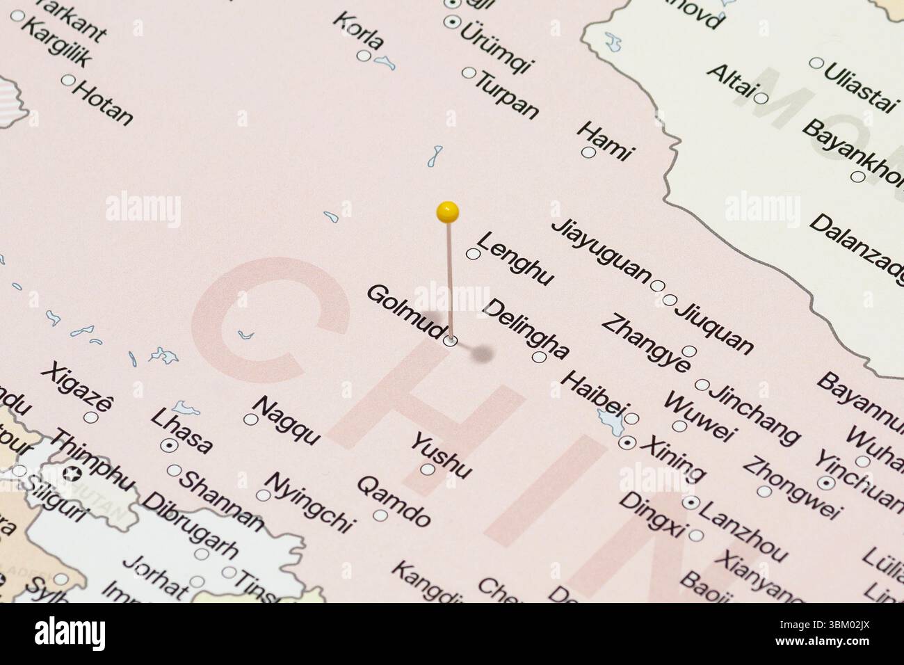 macro photo of a yellow pin needle into Golmud city of China political ...
