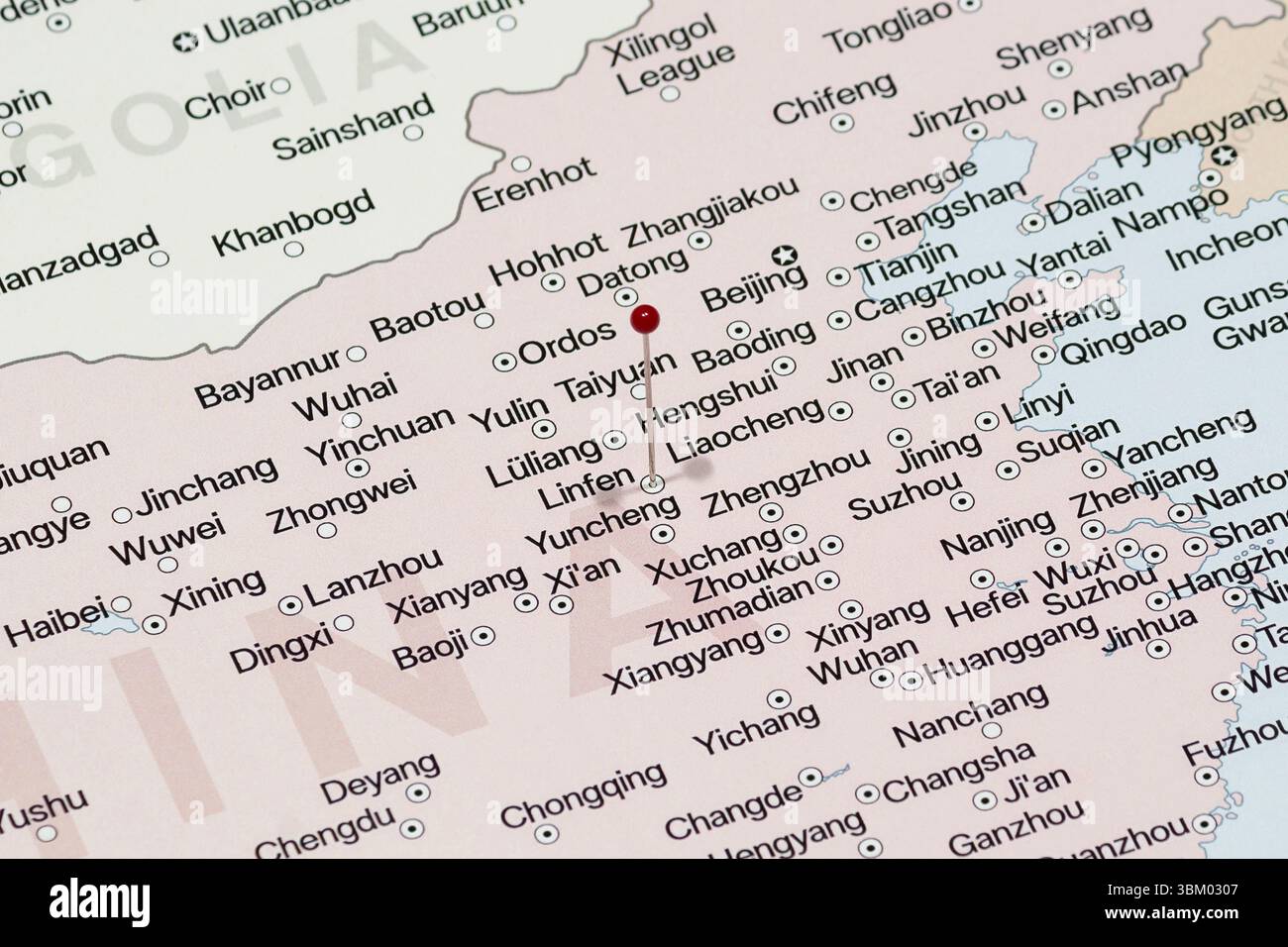 macro photo of a red pin needle into Linfen city of China political map ...
