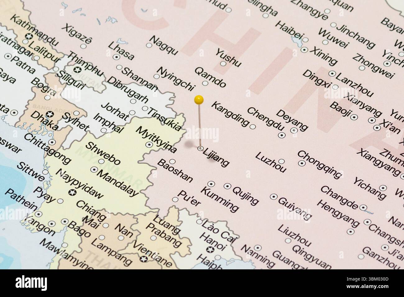 macro photo of a yellow pin needle into Lijiang city of China political ...