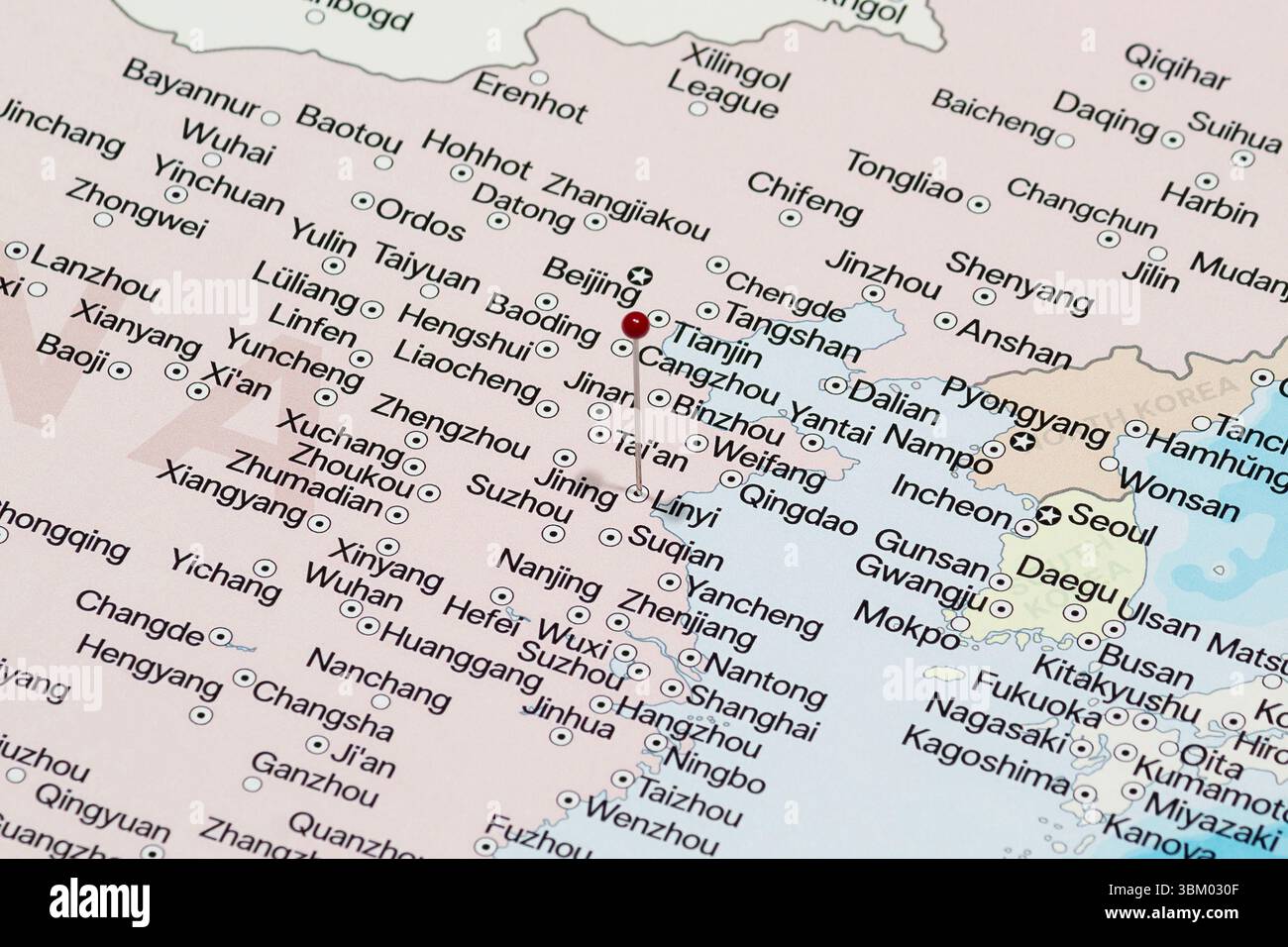 macro photo of a red pin needle into Linyi city of China political map ...