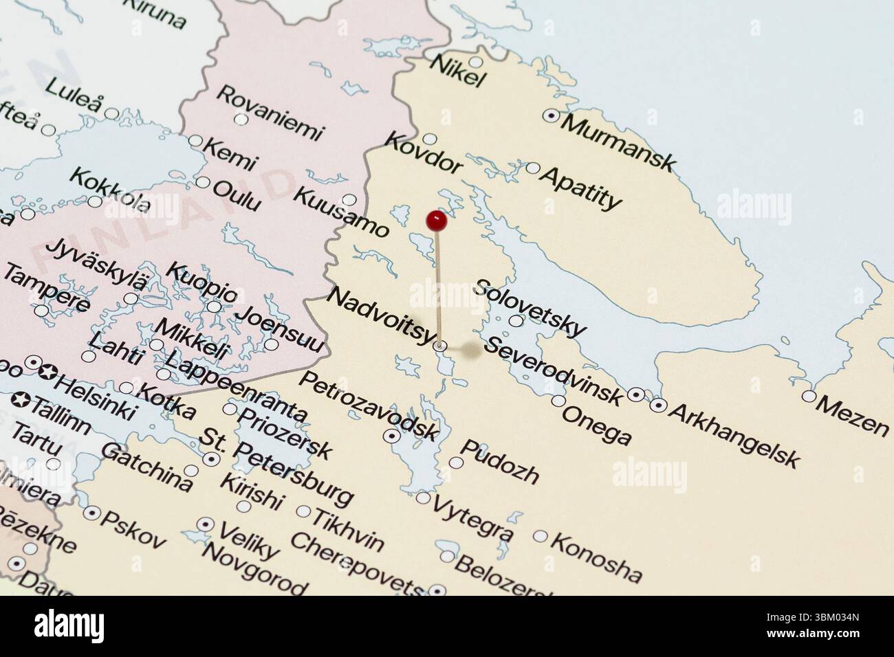 macro photo of a red pin needle into Nadvoitsy city of Russia political ...
