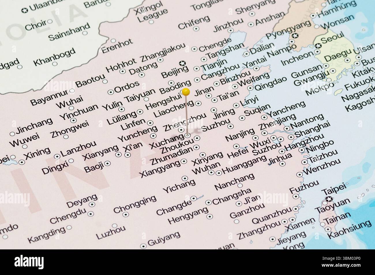 macro photo of a yellow pin needle into Xuchang city of China political ...