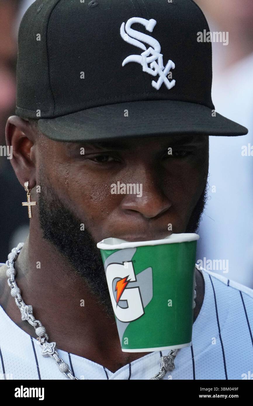 Chicago White Sox's Luis Robert Jr. carries a cup in the dugout before ...