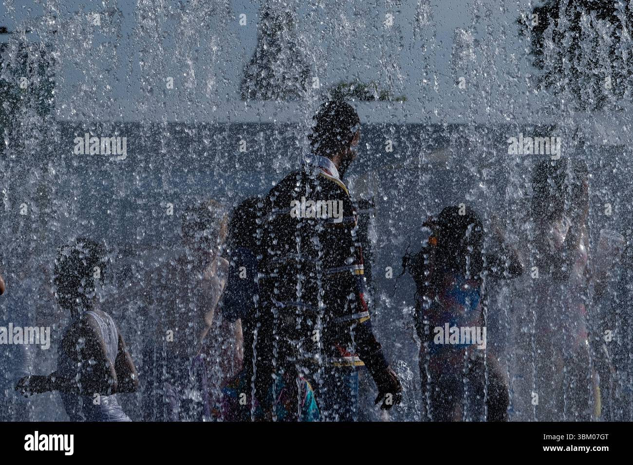 People enjoy cooling down at the Disappearing Rooms water fountain ...