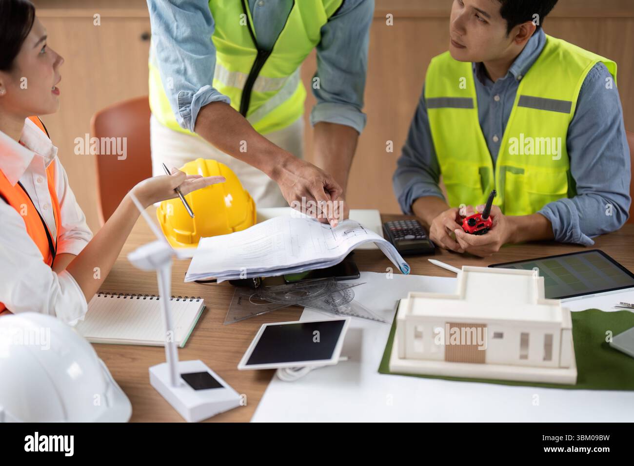 Sustainable Architecture Discussion. Team collaborating on eco-friendly ...